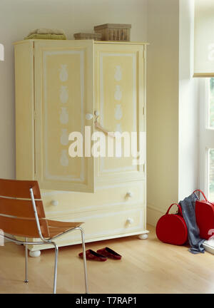 Painted yellow wardrobe in bedroom interior Stock Photo - Alamy