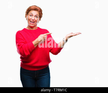 Atrractive senior caucasian redhead woman wearing christmas hat over ...