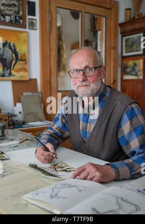 Willmersdorf, Germany. 07th May, 2019. The artist Reiner Zieger sits in ...