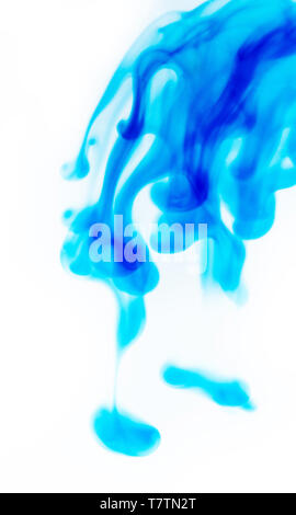 Light blue liquid drops of paint color flow down on isolated white ...