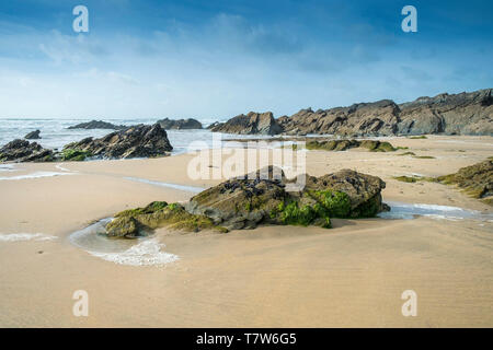Rocks exposed by a low tide at Fistral Bay in Newquay in Cornwall in ...
