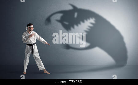 Young karate man fighting with a big black scary shadow Stock Photo - Alamy