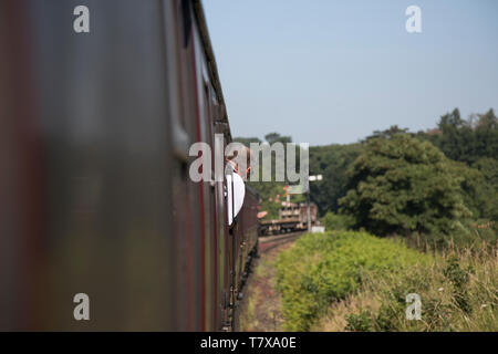 Railroad travel leaning out the window Stock Photo - Alamy