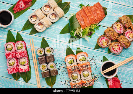 Set of maki roll and green leaves palm on stone table. Copy space Stock ...