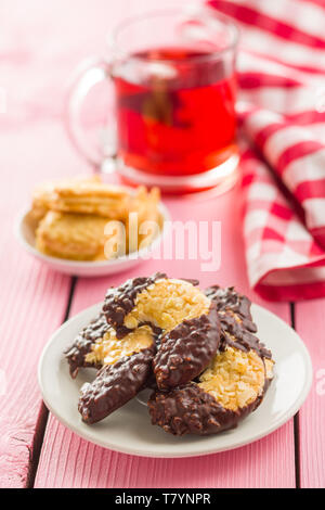 Homemade Sweet Cookies on a pink plate on a black surface, top view ...