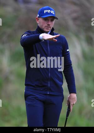 Matt Wallace reacts after his putt on the 18th green during the final ...