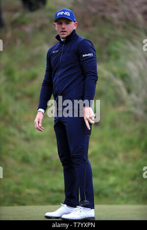 Matt Wallace reacts after his putt on the 18th green during the final ...