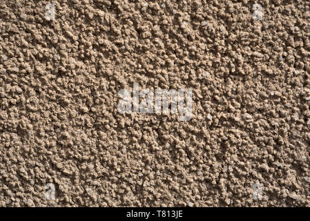 The outer wall of building with rough masonry and a decorative recess ...