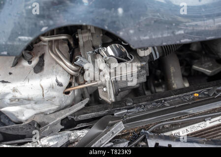 Volkswagen Badge, smashed badge and engine components. Car crash ...