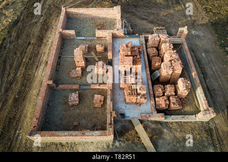 Aerial view of building site. Trenches dug in ground and filled with ...