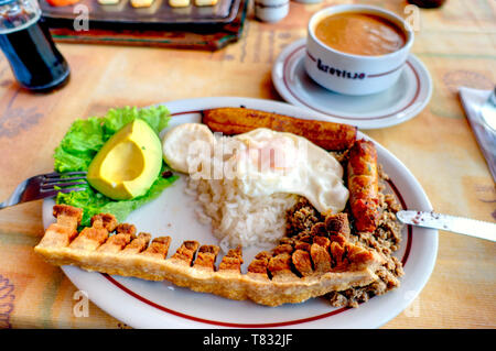 A traditional dish from Colombia - Bandeja Paisa, includes ground beef ...