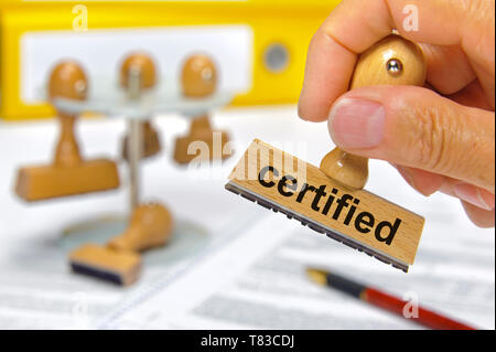 attestation printed on rubber stamp in hand Stock Photo - Alamy
