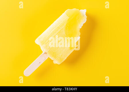 top view yellow popsicle with bites on a yellow background Stock Photo ...
