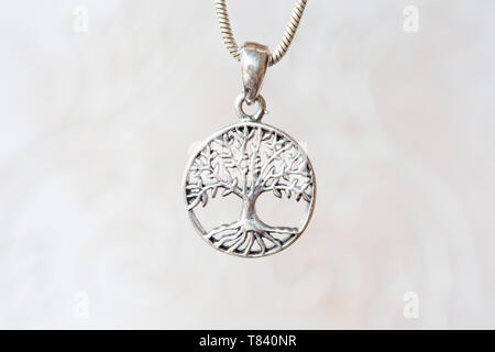 Silver tree in madala pendant on natural white background Stock Photo ...