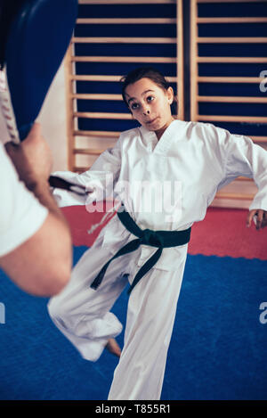 Taekwondo instructor working with girl Stock Photo - Alamy