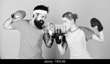 Woman knockout man in boxing pose. Woman looking on floor laying male ...