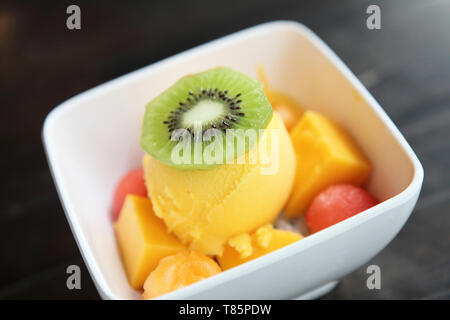 Scoops of mango ice cream with fruit Stock Photo - Alamy