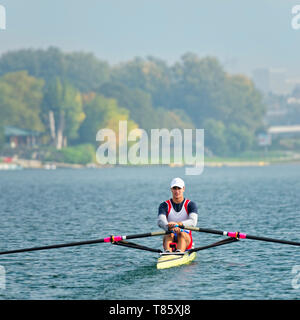Sportsman single scull man rower carrying boat to competition Stock ...