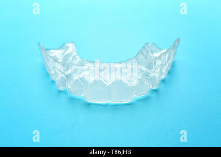 Occlusal splint on color background Stock Photo - Alamy