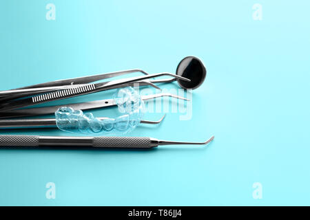 Dental instruments and occlusal splint on color background Stock Photo ...