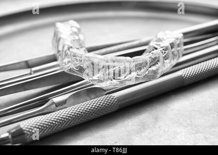 Tray with dental instruments and occlusal splint on color background ...