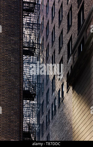 Alleyway between two buildings one brick wall one wooden wall line the ...