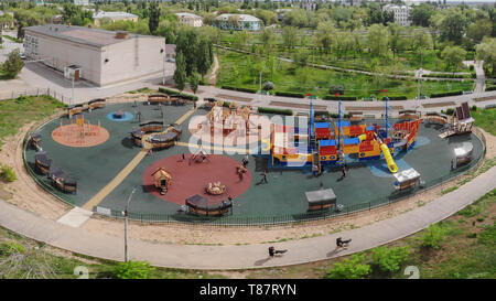 Aerial view of a park with playground equipment tennis courts and a ...