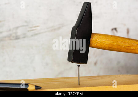 Black man hammering nail at construction site Stock Photo - Alamy