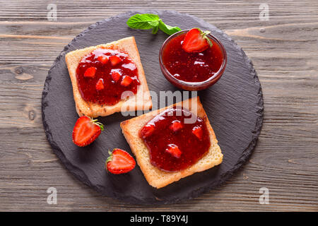 Composition with tasty strawberry jam on wooden table Stock Photo - Alamy