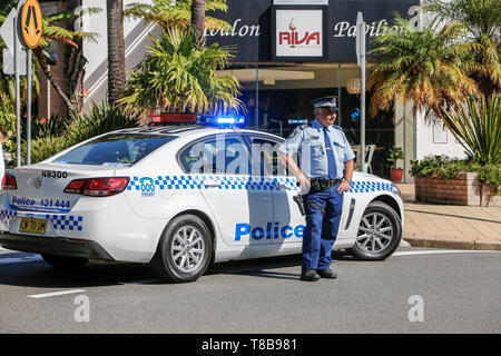 Sydney police officer stood by his police car during ANZAC day march in ...