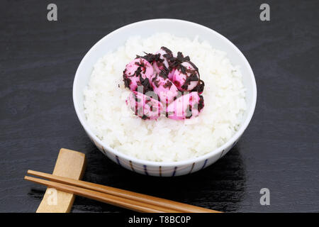 Japanese cooked white rice with shiso pickled garlic on a bowl Stock ...