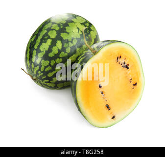 Whole and cut yellow watermelons on wicker table outdoors, closeup ...