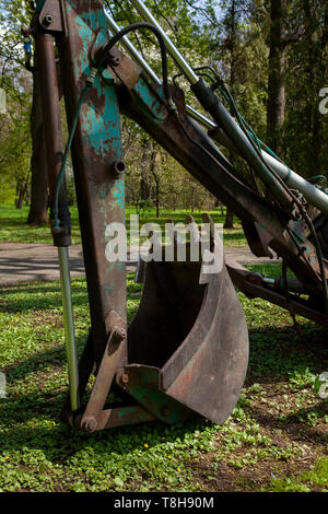 Tractor on grass with big dipper in the garden. Old harvest or ...