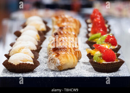 Tray of small delicious Italian pastries. Mignon high pastry Italian ...