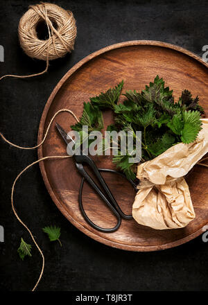 Nettle leaf, freshly picked Urtica dioica on wooden table, top view ...
