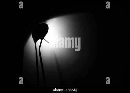 Table lamp casting light on dark wall Stock Photo - Alamy