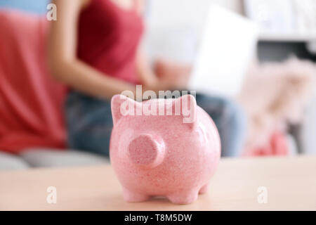 Cute piggy bank on wooden table with white background Stock Photo - Alamy