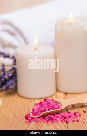 lavender salt in wooden spoon and lavender flowers on a pink background ...