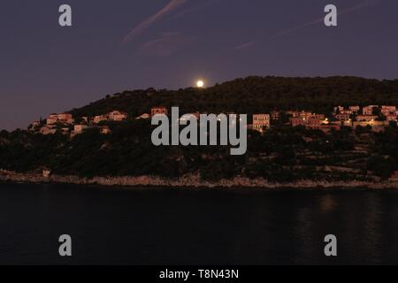The moon setting at dawn over the French Riviera Stock Photo - Alamy