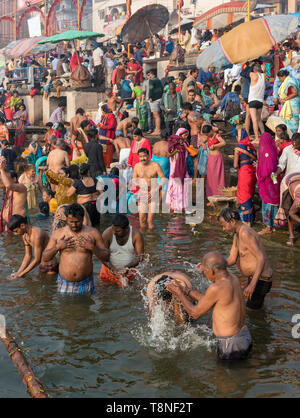 Hindu believers bath and perform ritual bath and puja prayers at ghats ...