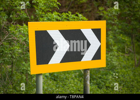 Sharp right hand bend sign on a country road in UK Stock Photo - Alamy