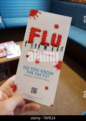 A leaflet with advice for patients about Flu is seen in an NHS local ...