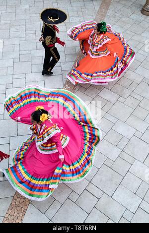 Mexican folk dancers perform the Jarabe tapatio or Mexican Hat Dance in the arcade style ...