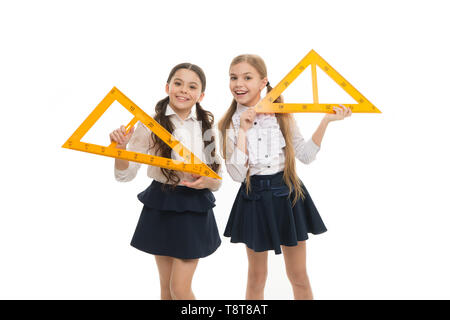 Geometry lesson is much fun. Little girls holding protractor and ruler ...