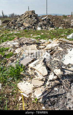 Construction concrete waste dumped in a wooded area and becoming ...
