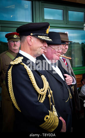 Winston Churchill next to King George delivering a speech in a re ...