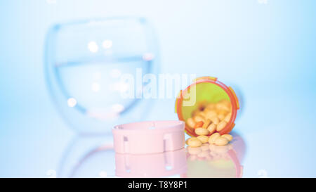 can of pills and a glass of water Stock Photo - Alamy