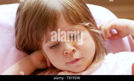 Little beautiful girl, baby infante, Caucasian. looks with his big blue ...