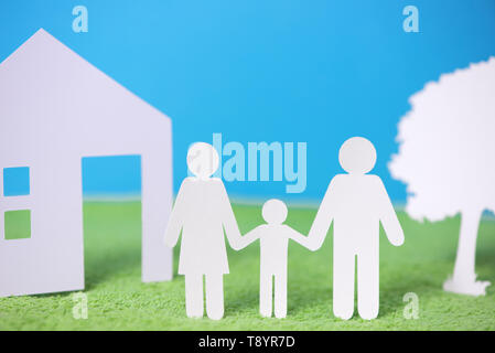 Paper cut of family with house and tree Stock Photo - Alamy