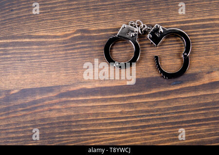 handcuffs on dark background Stock Photo - Alamy